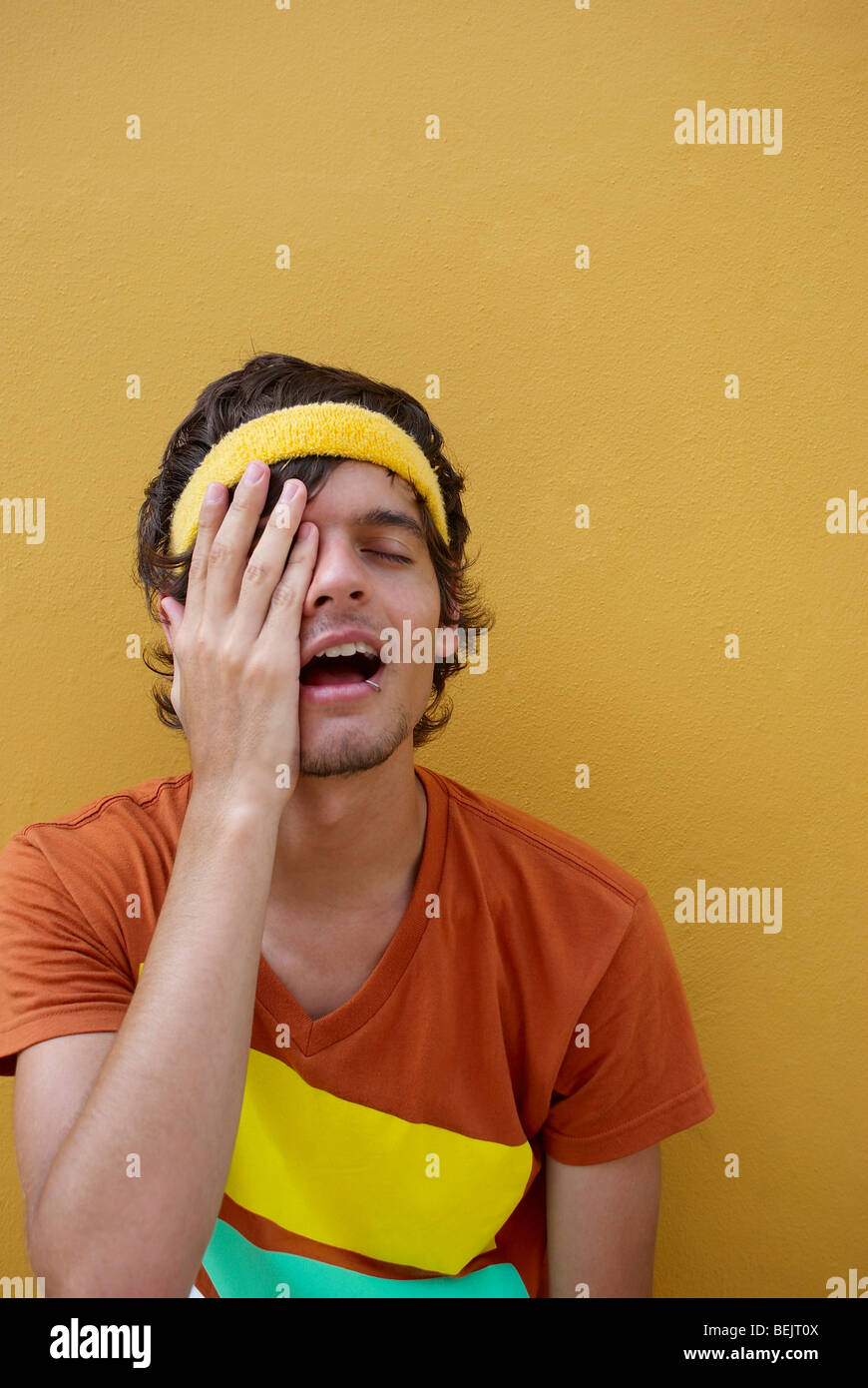 Young man with his hand on his eye Stock Photo - Alamy
