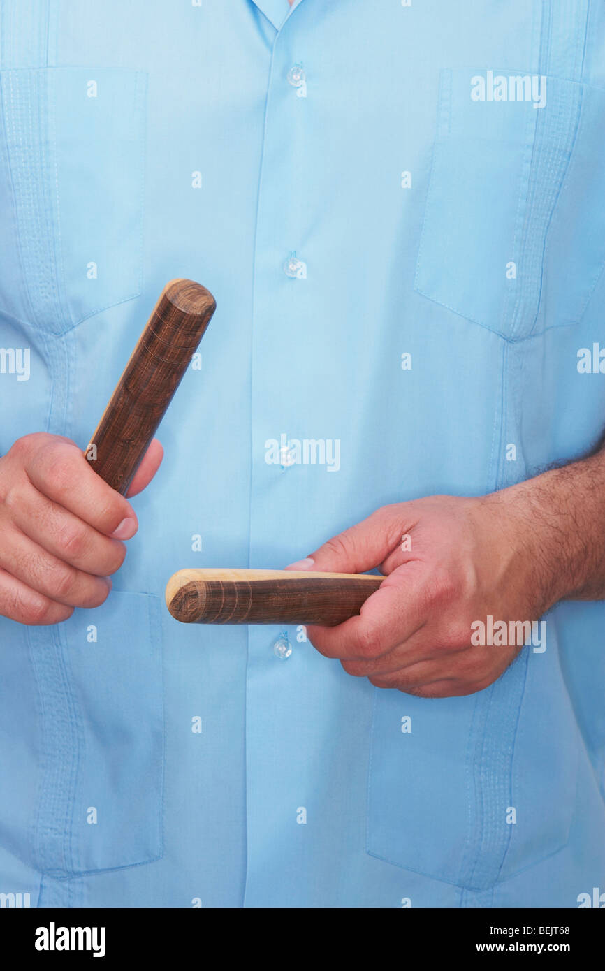 Mid section view of a man holding a pair of claves Stock Photo - Alamy