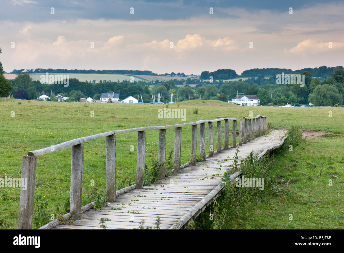 Wooden footbridge over an area of marsh near the River Thames in ...