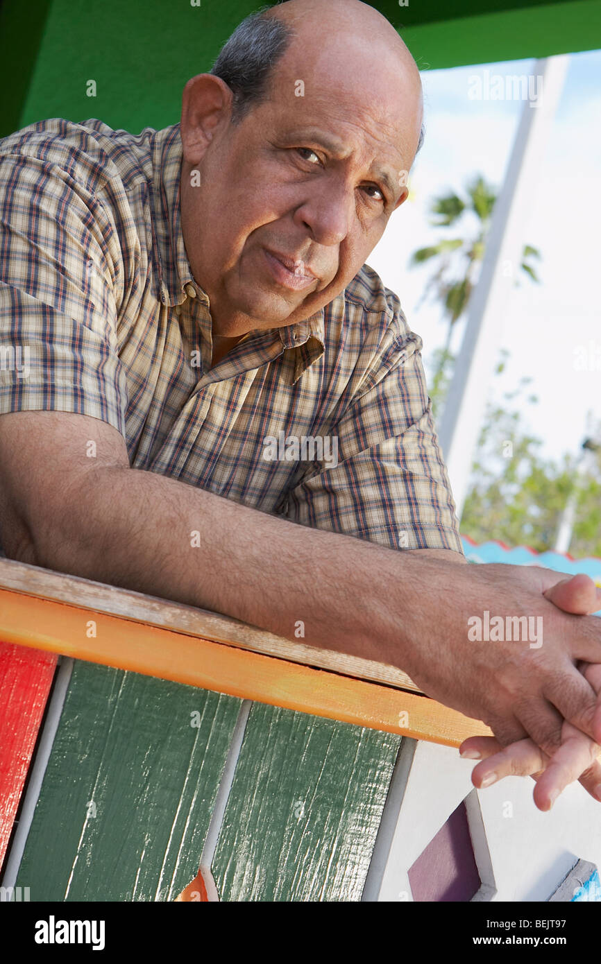 Portrait of a senior man leaning on a railing Stock Photo - Alamy