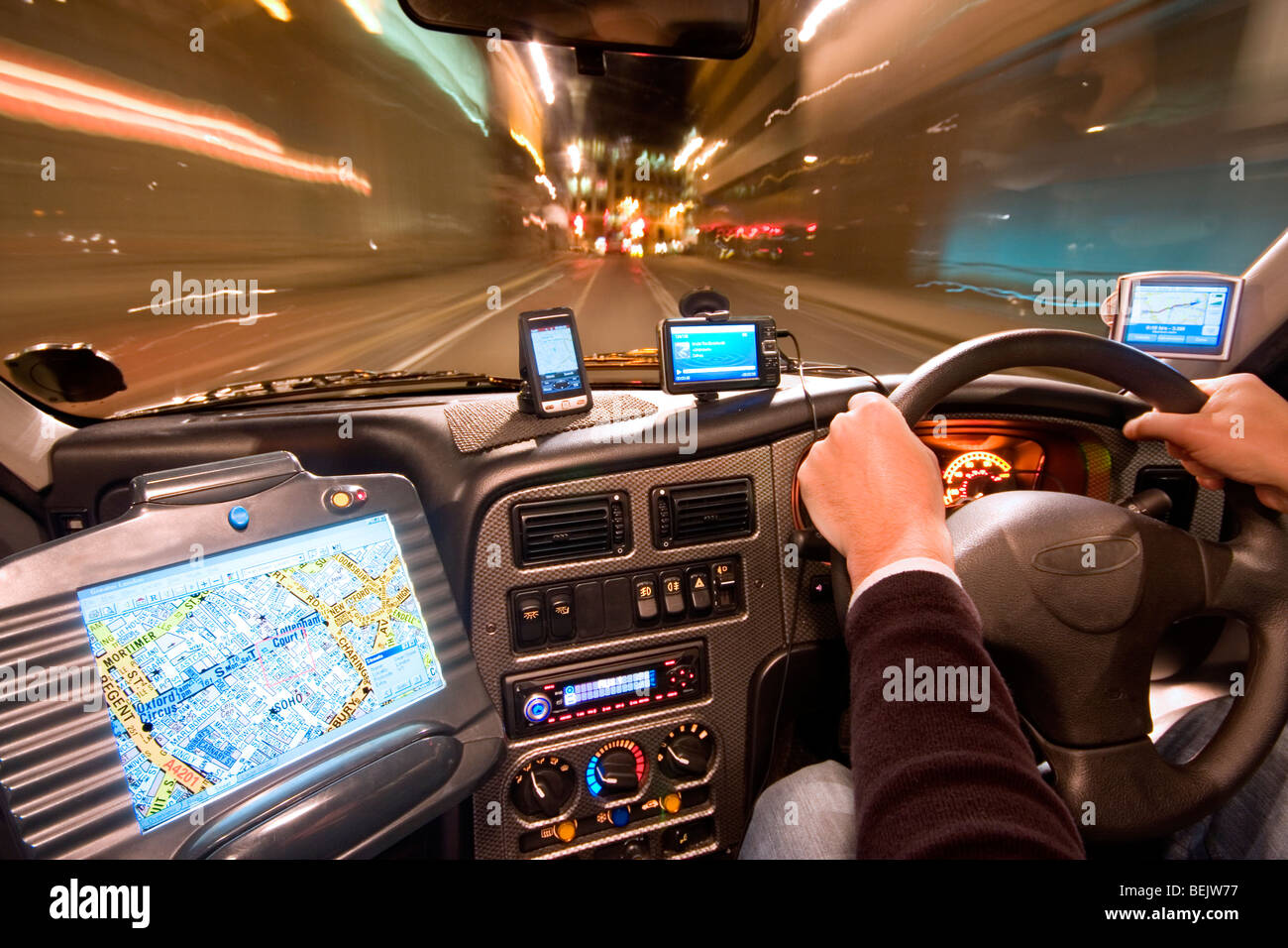 In side a London Taxi while driving at night with light trails Stock ...