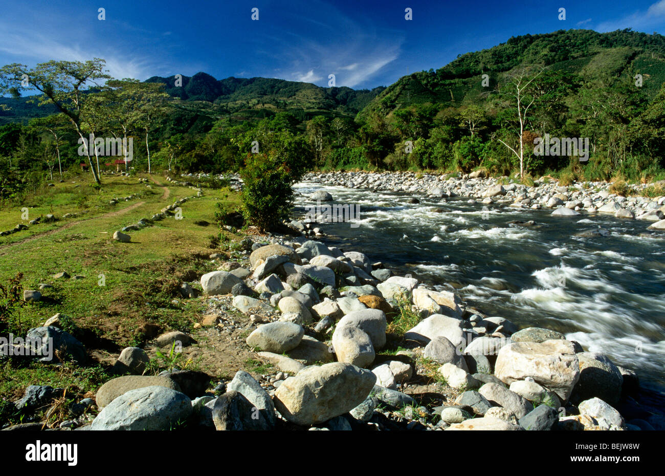 Rio Reventazon. Rocks. Hillside. Pathway. Trees. Blue sky. RIVER. OROSI ...