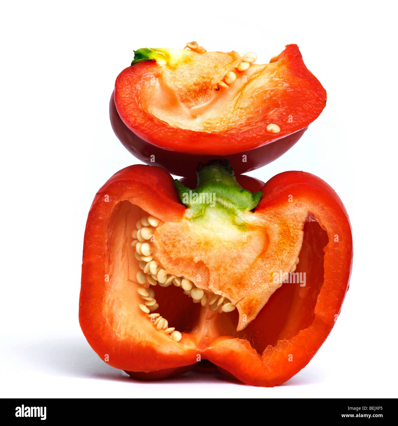 Red bell pepper cut in half showcasing seeds and interior detail in a ...