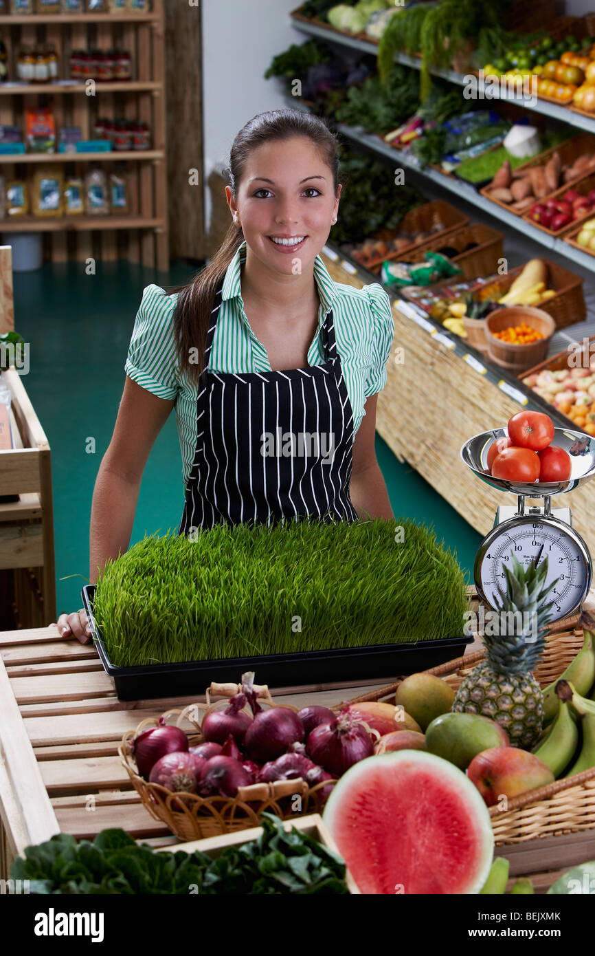 Portrait of a young woman standing in a grocery store and smiling Stock ...