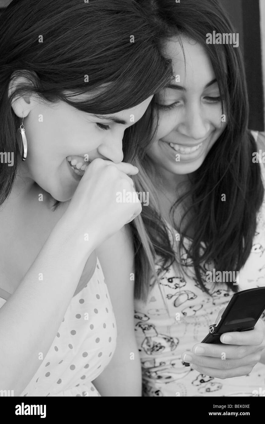 Young friends smiling sitting Black and White Stock Photos & Images - Alamy