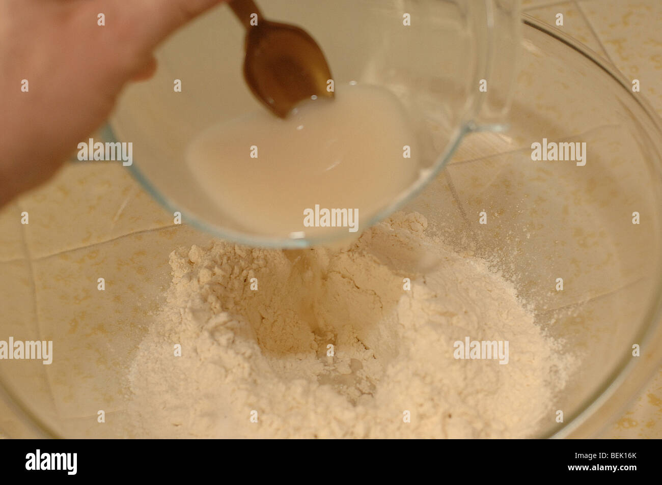 Mixing of ingredients in preparation for baking a loaf of sourdough ...