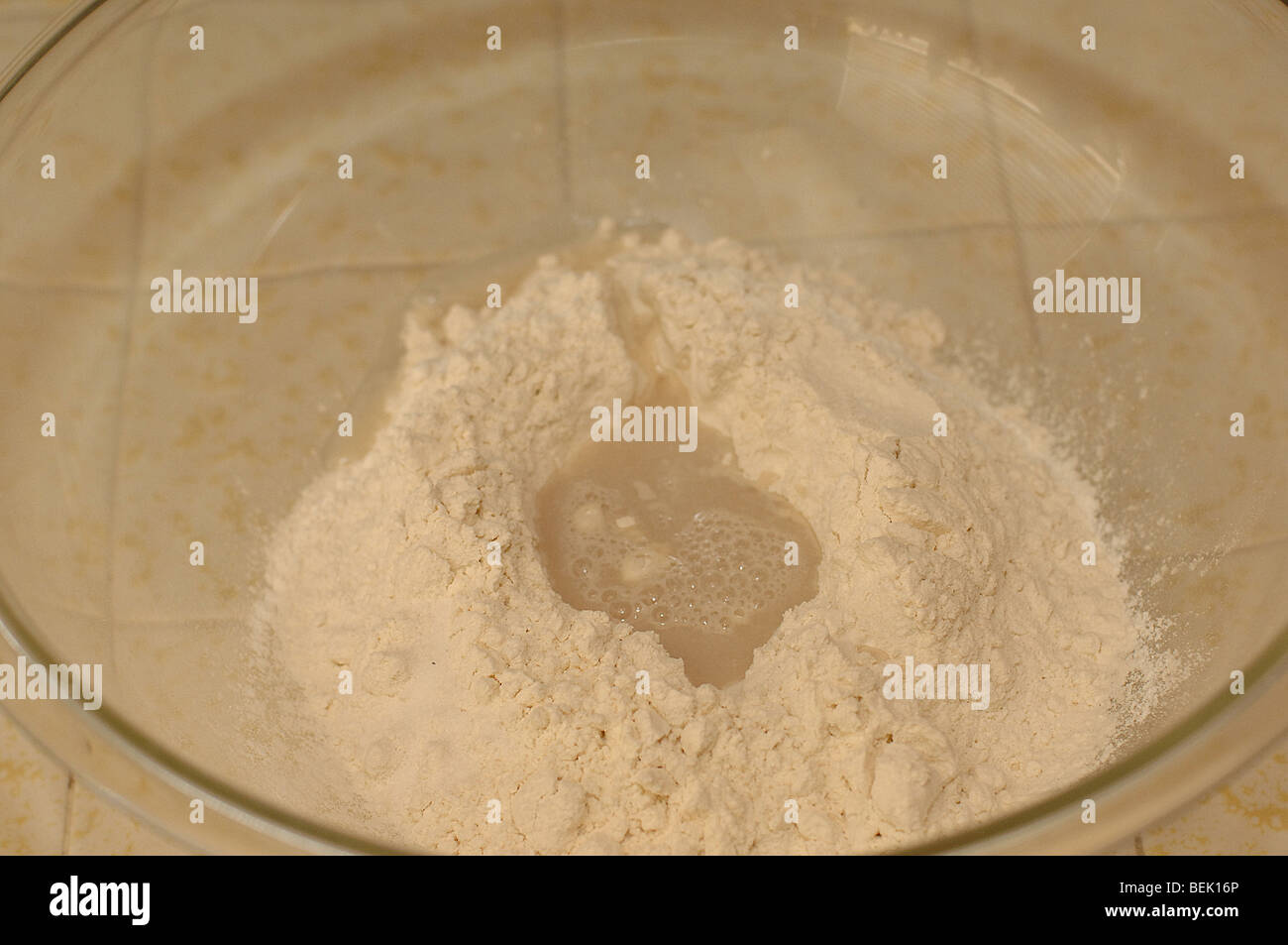 Mixing of ingredients in preparation for baking a loaf of sourdough ...
