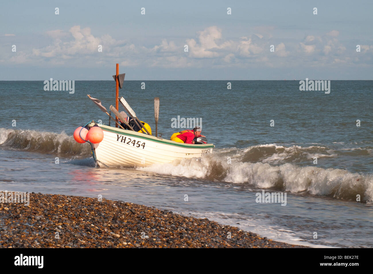 Fishing boat coming to shore Stock Photo - Alamy