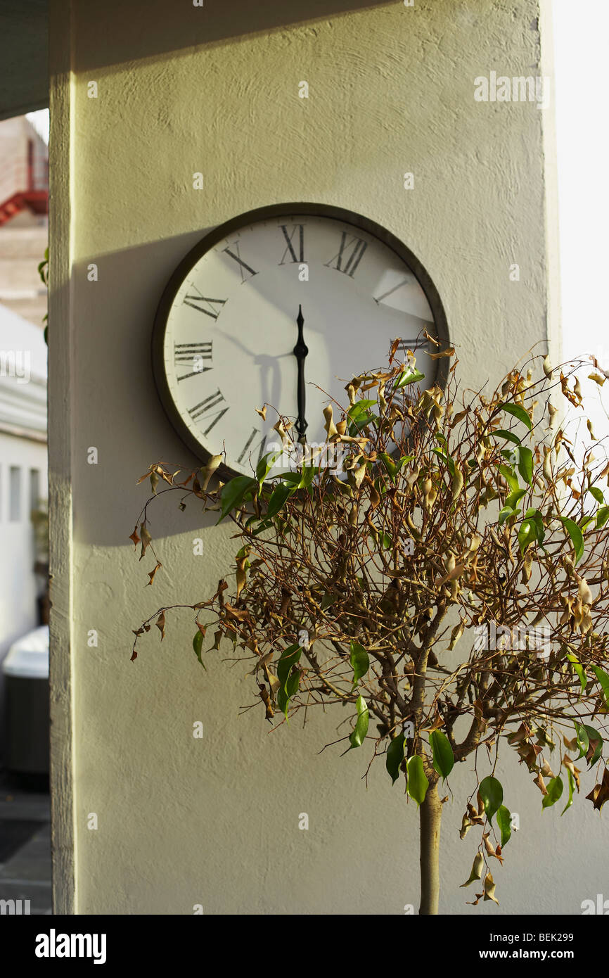 Clock hanging on a wall Stock Photo - Alamy