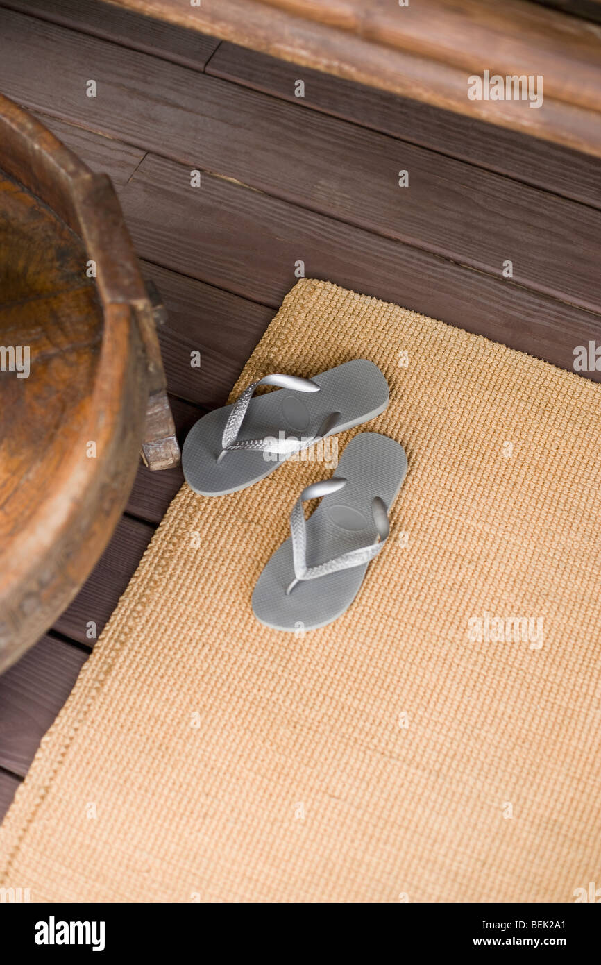 Flip flops on rug Stock Photo - Alamy