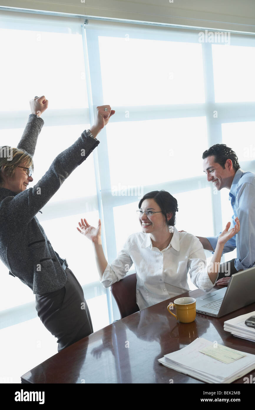 Two businesswomen and a businessman cheering up Stock Photo - Alamy