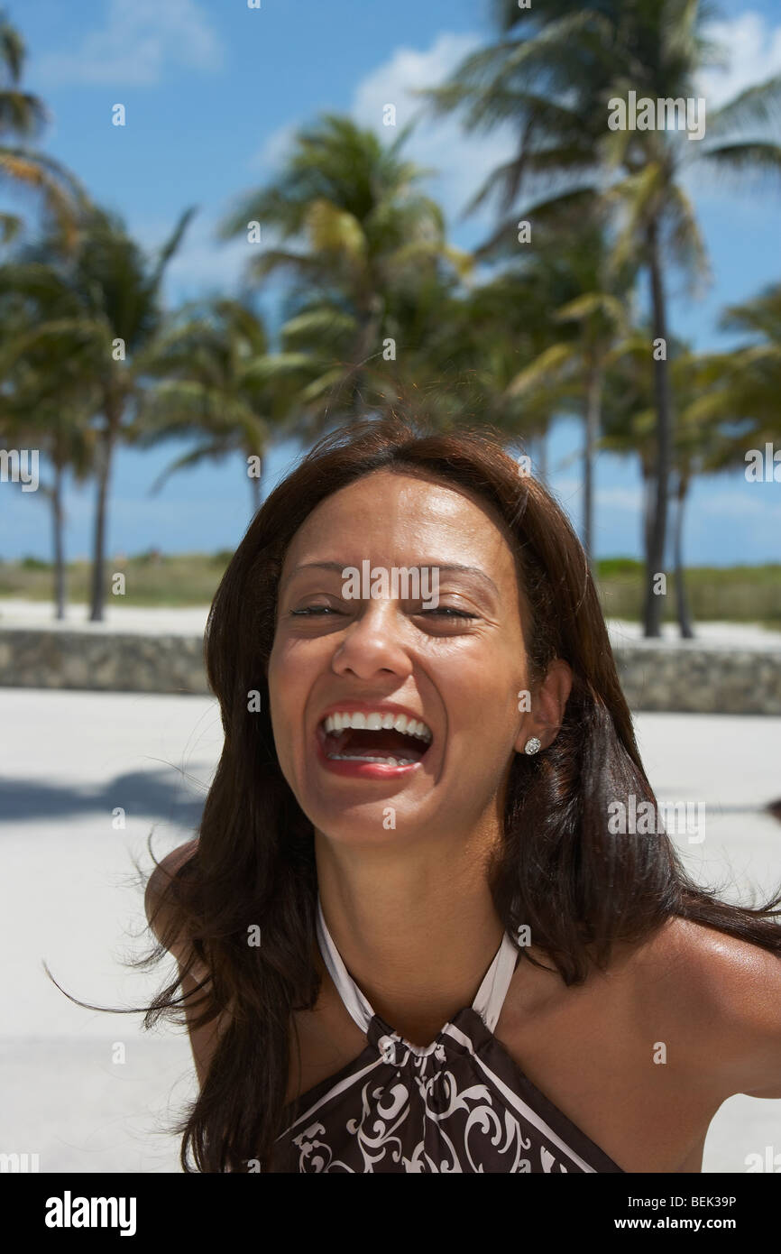Portrait of a mature woman laughing on the beach, South Beach, Miami ...