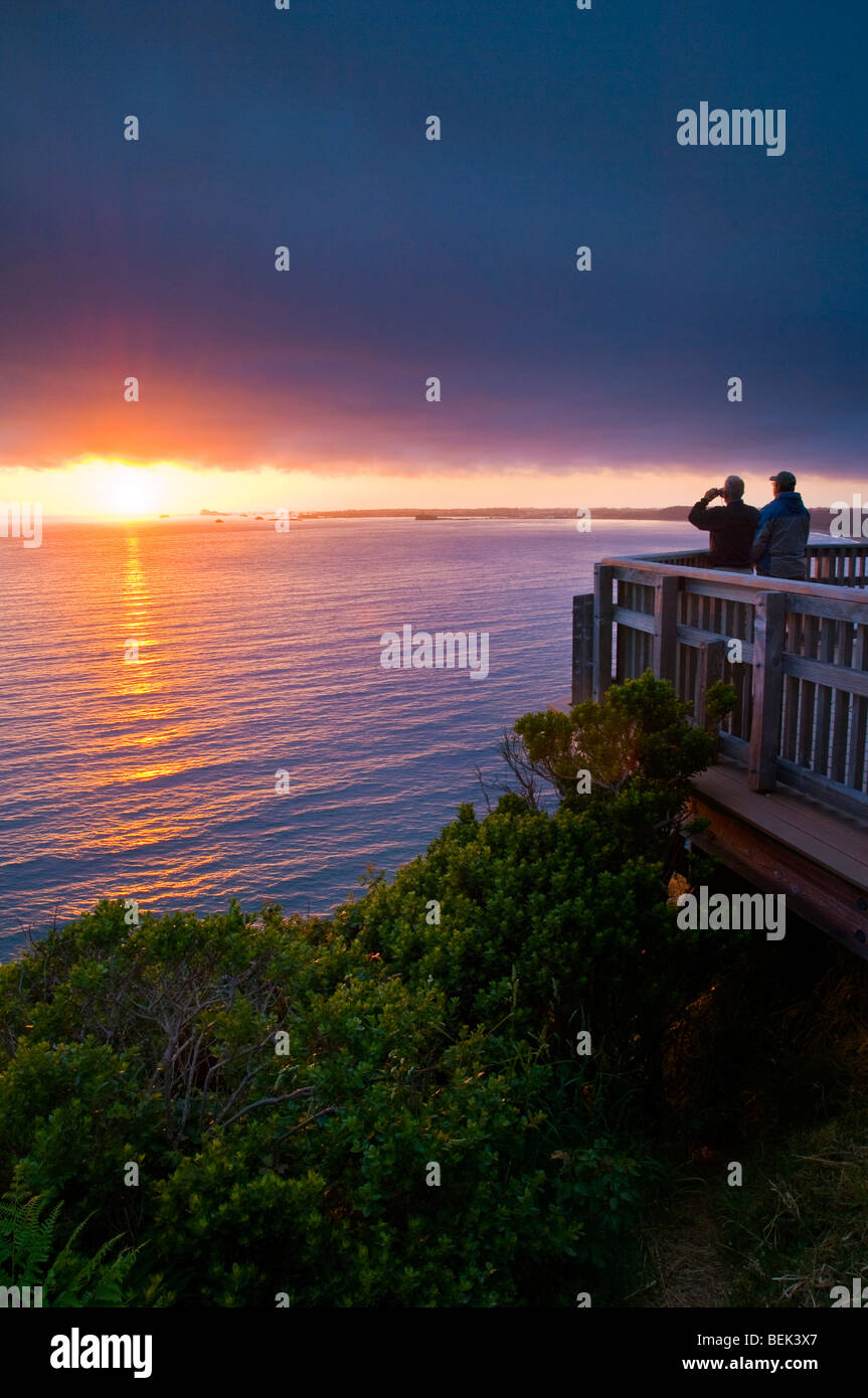 People watching the sunset over the ocean from Enderts Beach Overlook ...