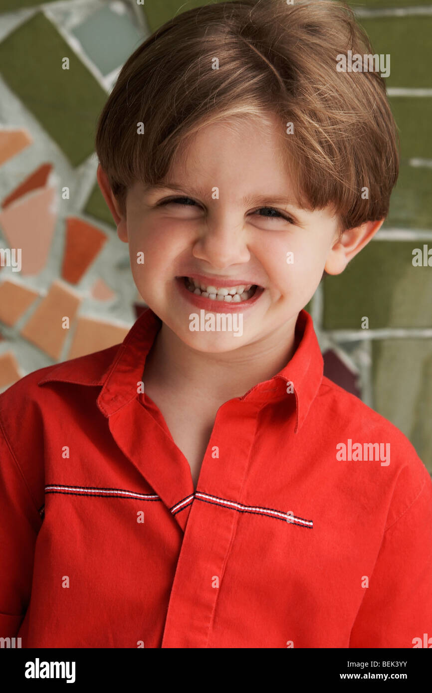 Portrait of a boy clenching his teeth Stock Photo - Alamy