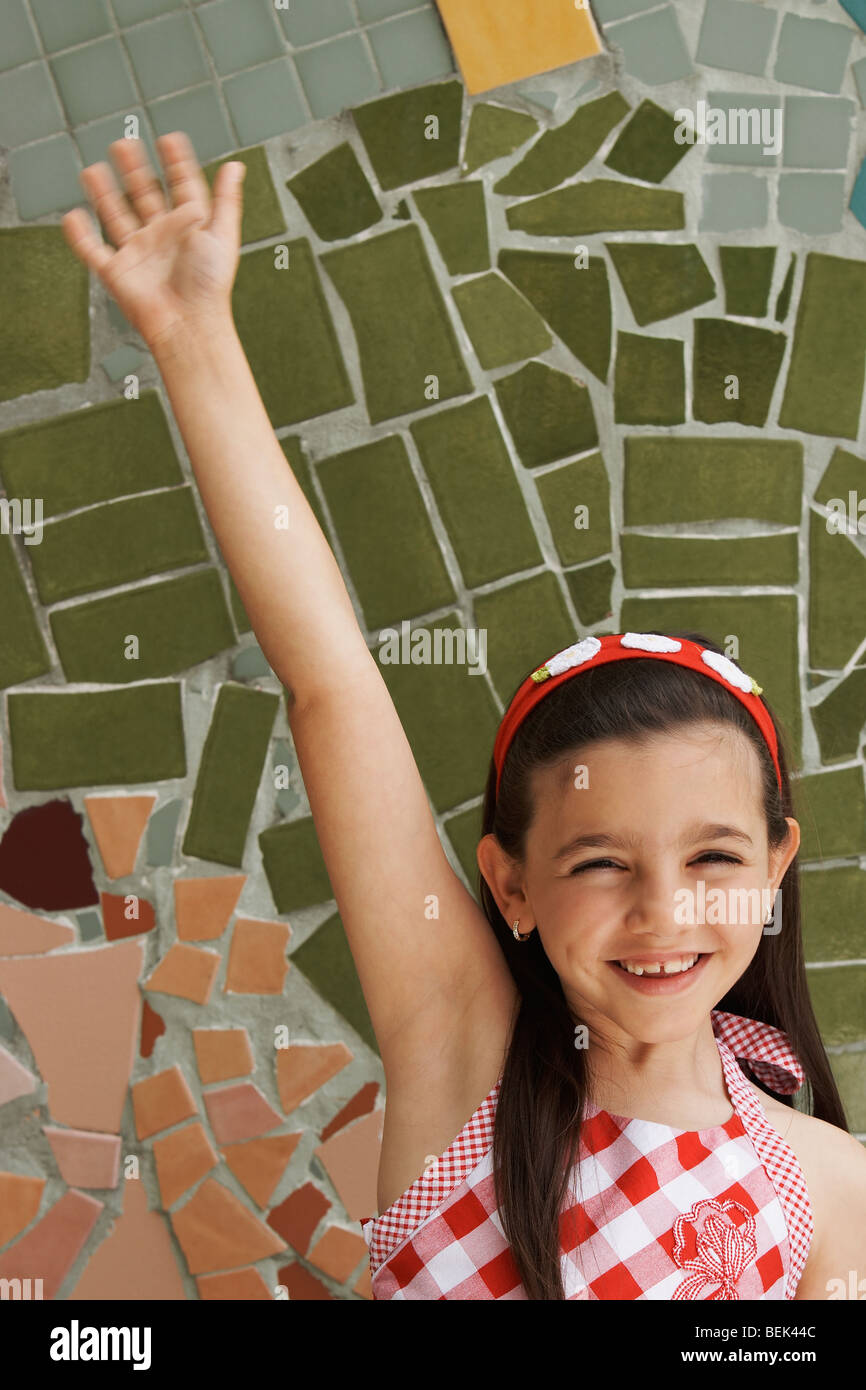 Portrait of a girl raising her hand Stock Photo - Alamy