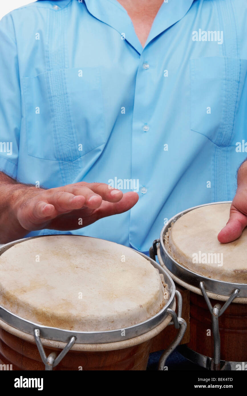 Mid section view of a man playing bongo drums Stock Photo - Alamy