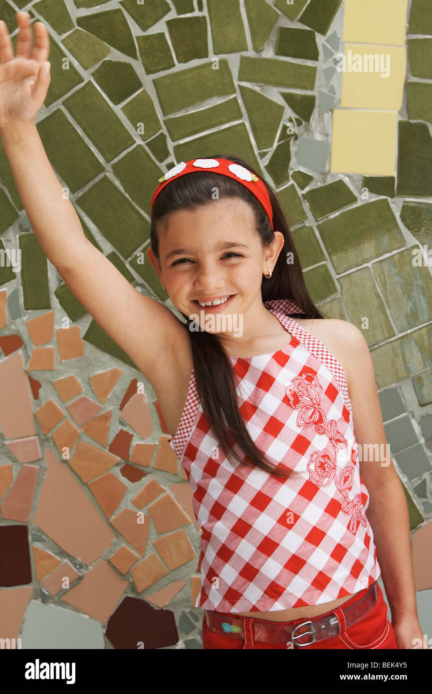 Portrait of a girl raising her hand Stock Photo - Alamy