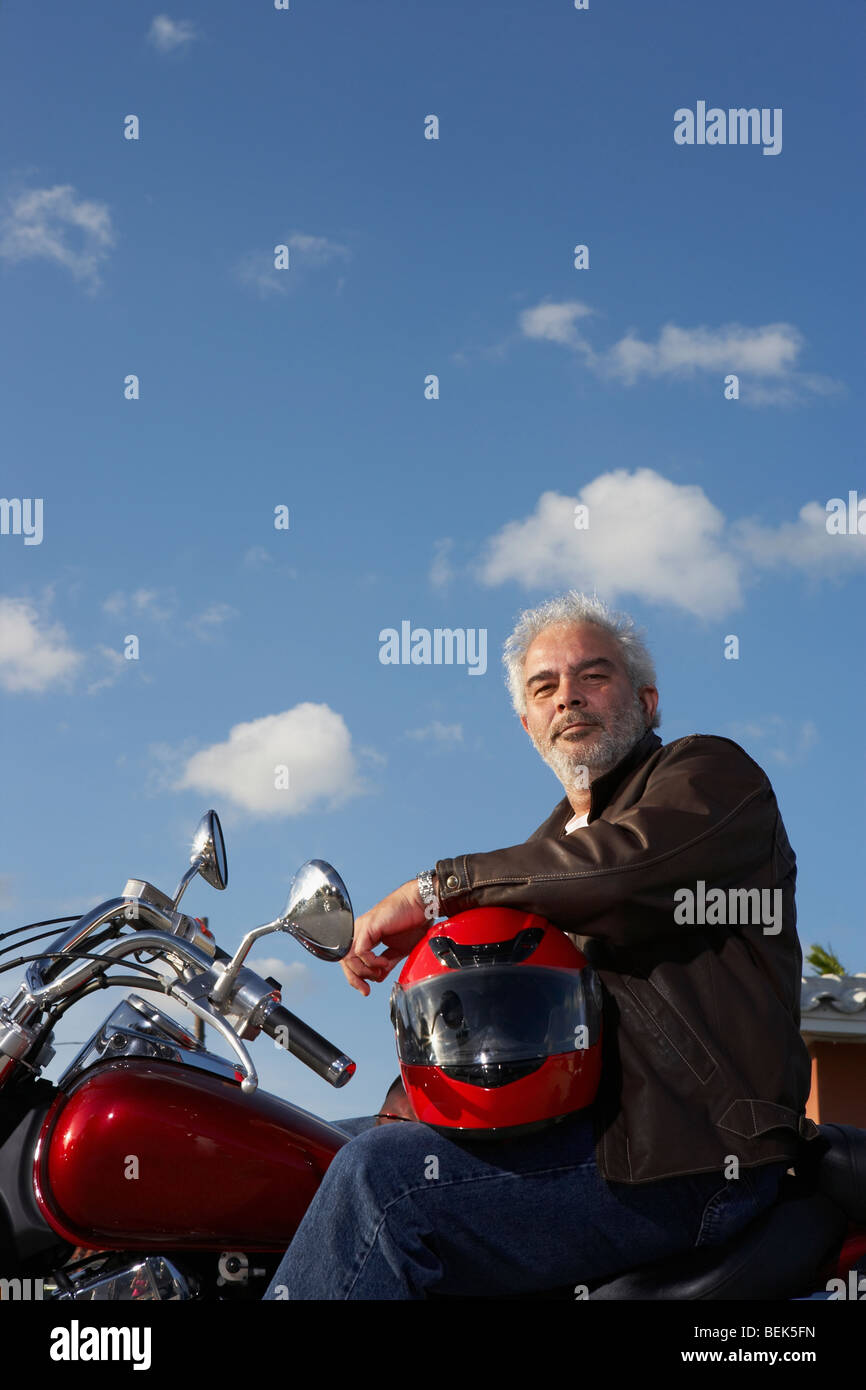 Portrait of a mature man sitting on a motorcycle Stock Photo - Alamy