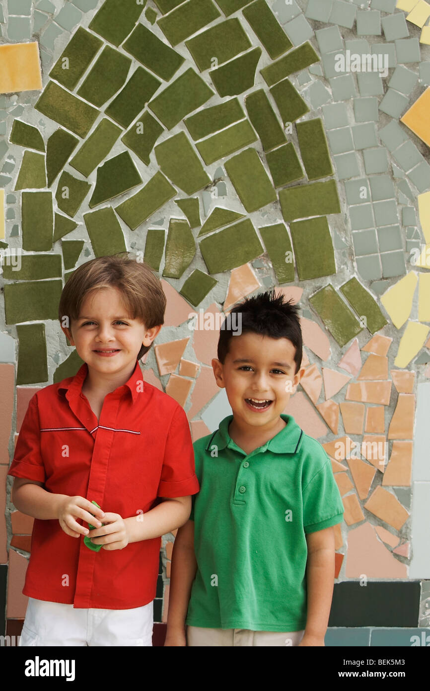 Portrait of two boys standing in front of a colorful wall Stock Photo ...