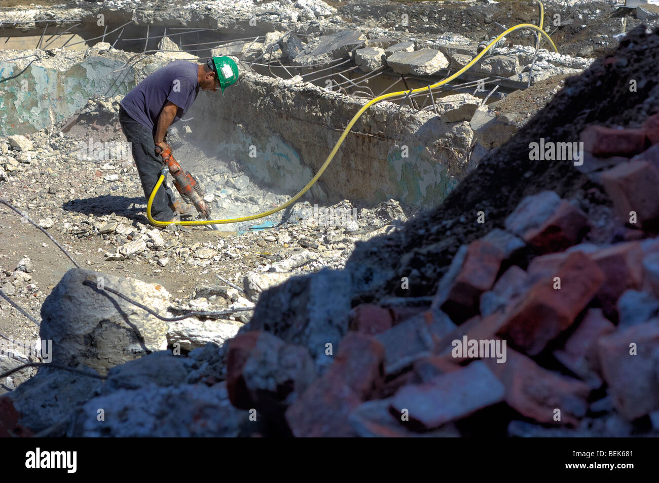 Construction Worker Excavates at a Construction Site Using a Jackhammer ...
