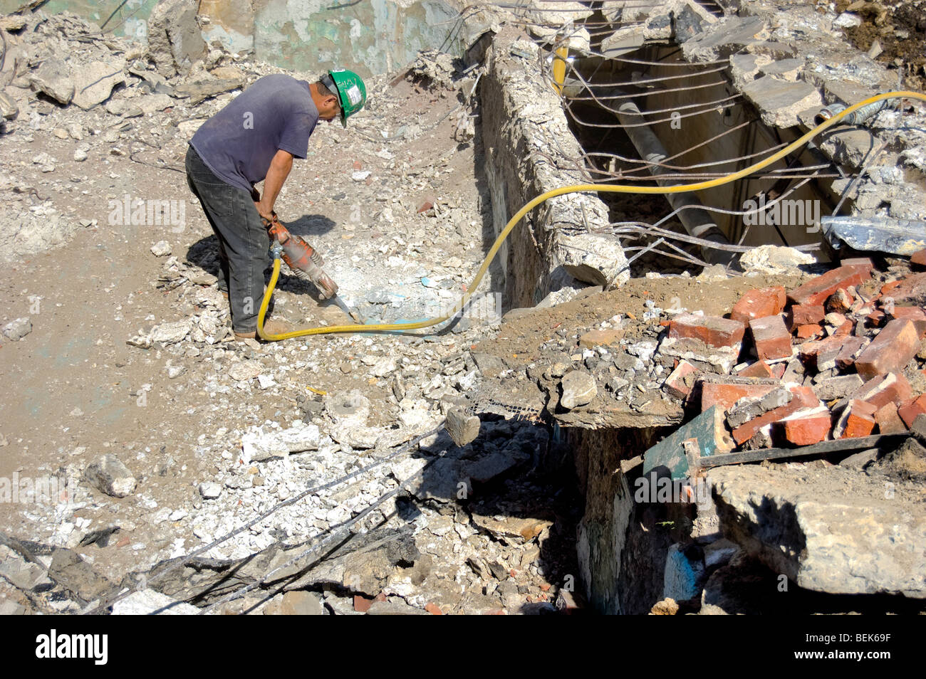 Construction Worker Excavates at a Construction Site Using a Jackhammer ...