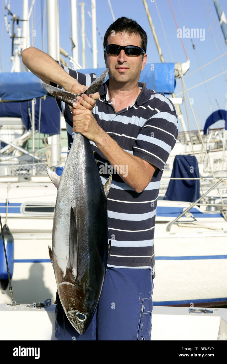 Big game fisherman with saltwater tuna catch in his hands Stock Photo ...