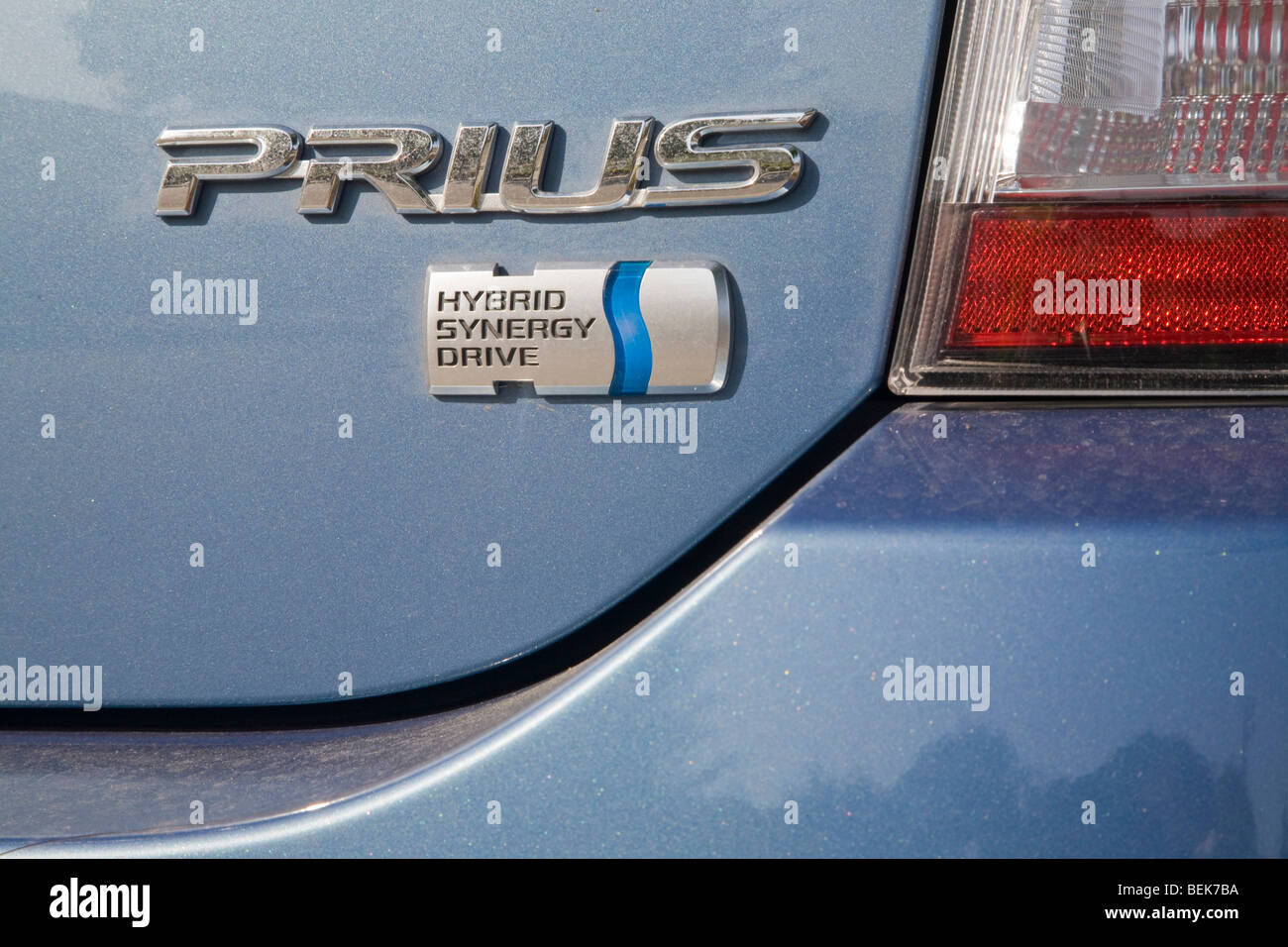 A close up of blue Toyota Prius with a Hybrid Synergy Drive sign ...