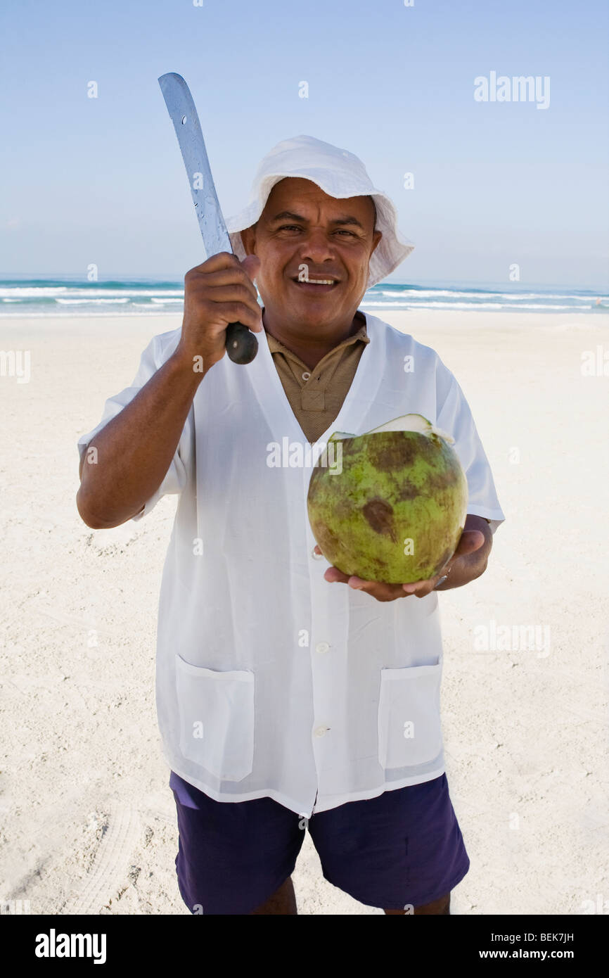 Man cutting a coconut with a machete Stock Photo - Alamy