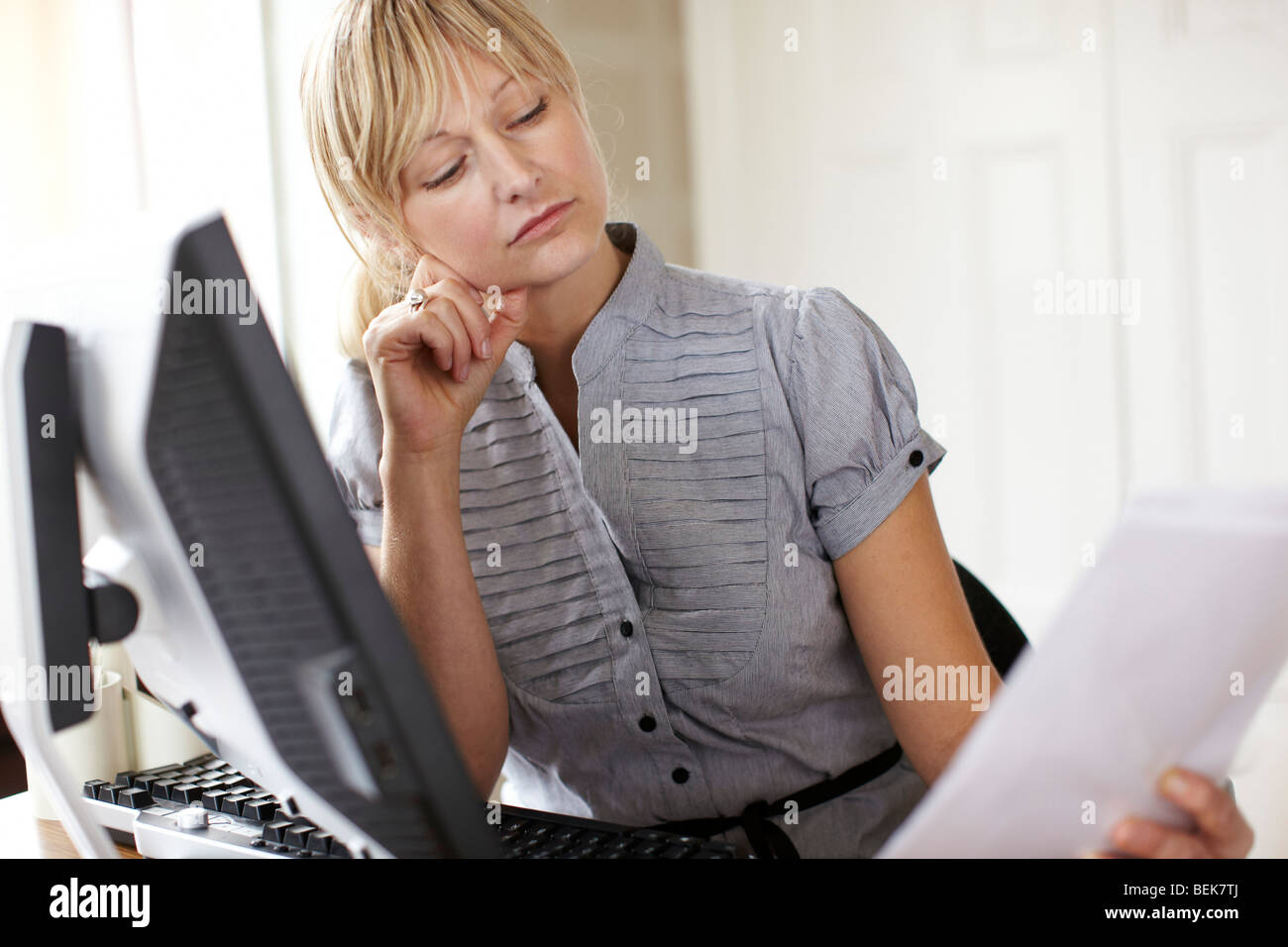 Woman sat at desk Stock Photo - Alamy
