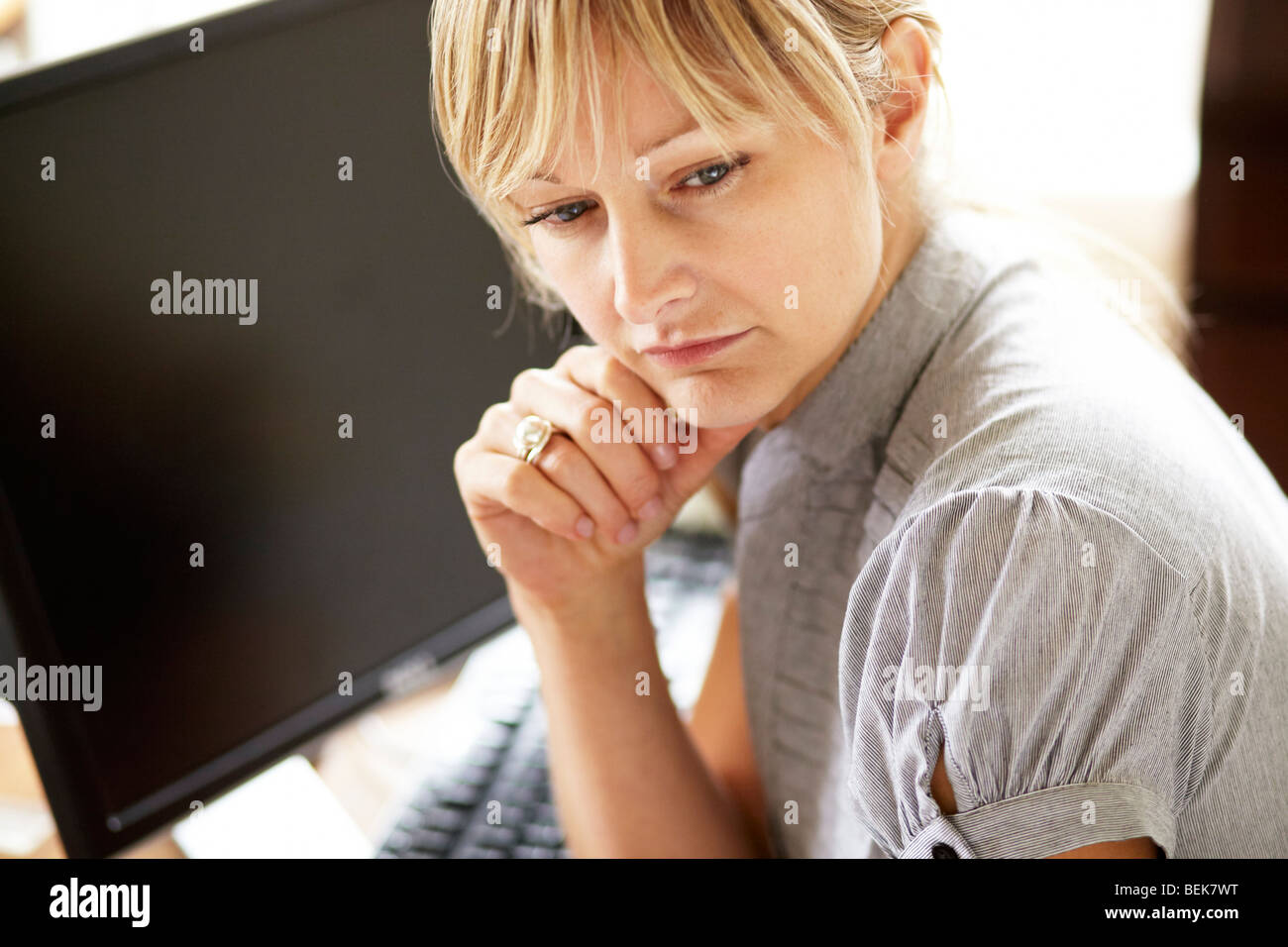 Woman sat at desk Stock Photo - Alamy