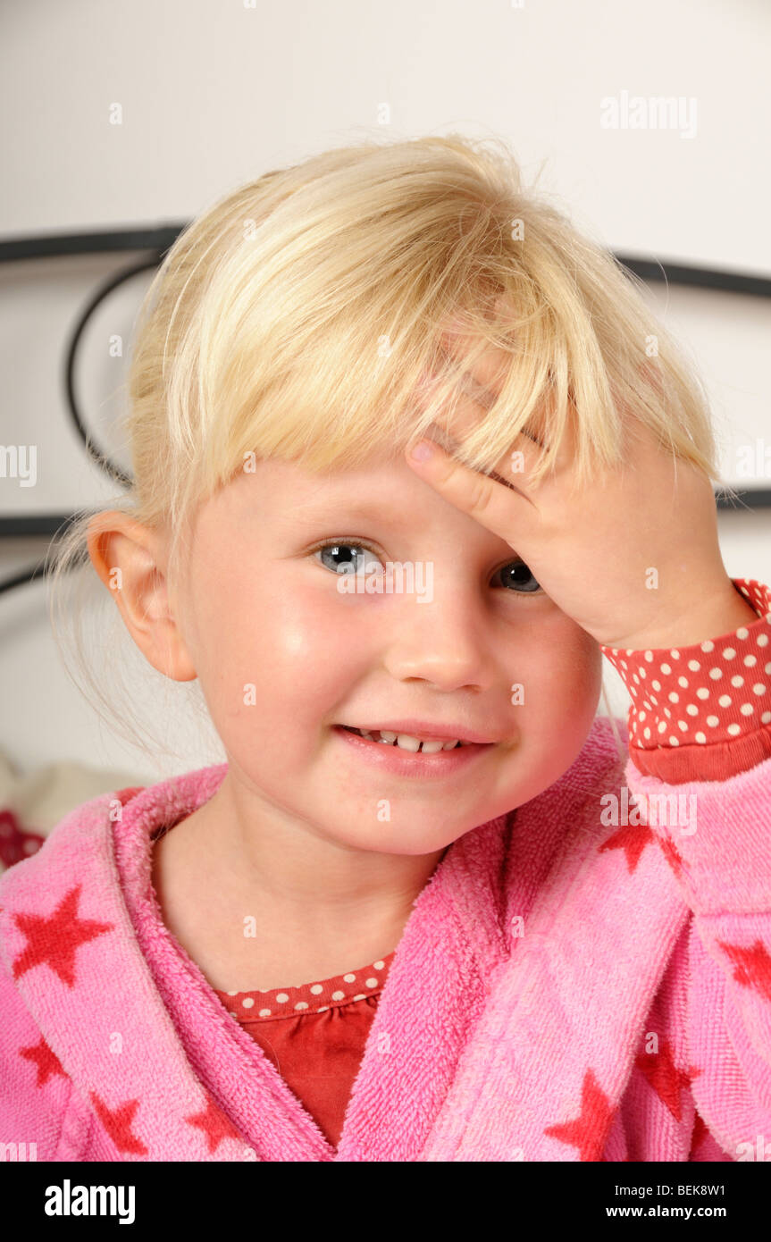 Stock photo of a 4 year old girl smiling whilst holding one hand to her ...