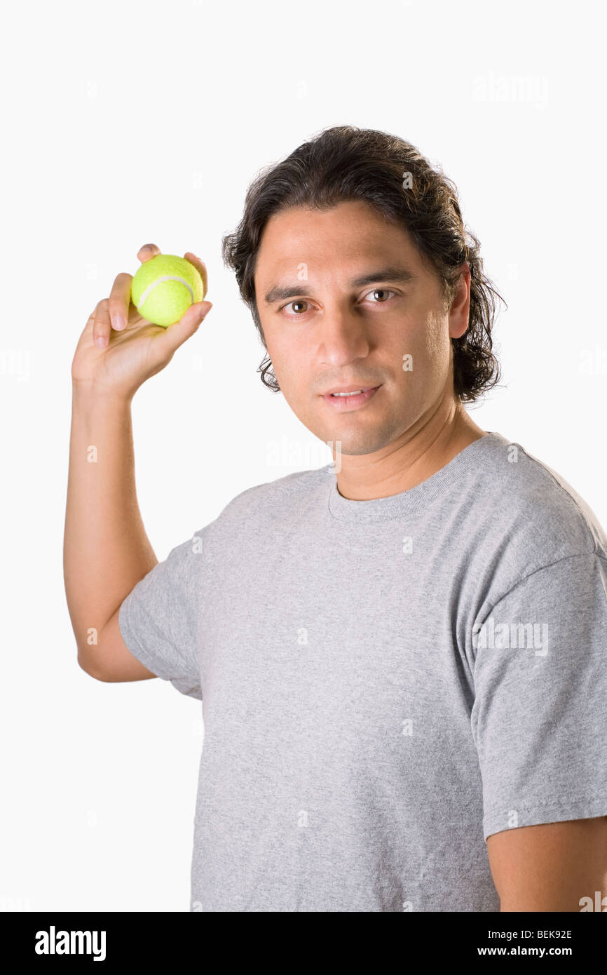 Man holding a tennis ball Stock Photo - Alamy