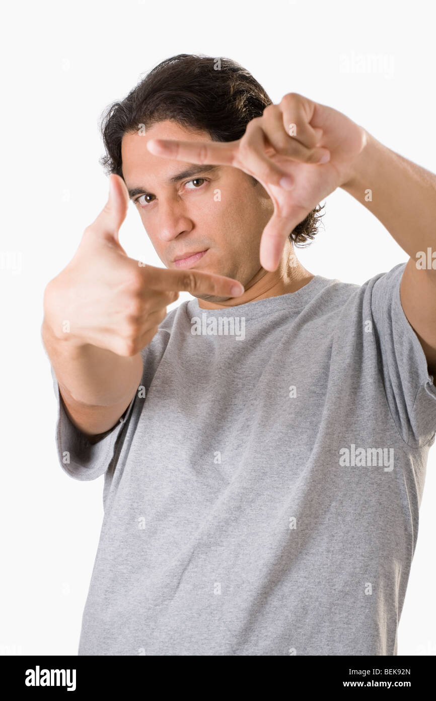 Man looking through the frame formed by fingers Stock Photo - Alamy