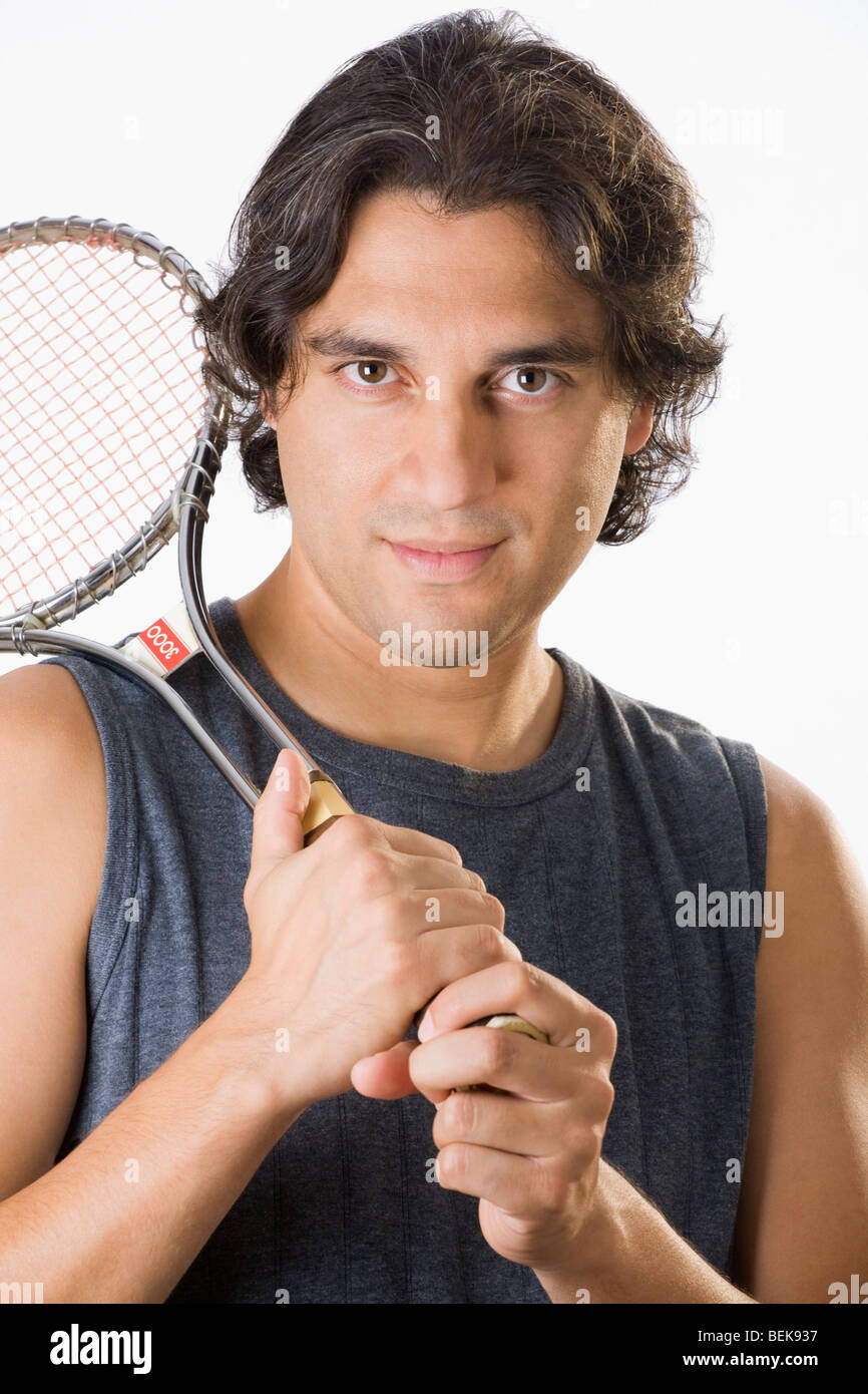Man holding a tennis racket Stock Photo - Alamy