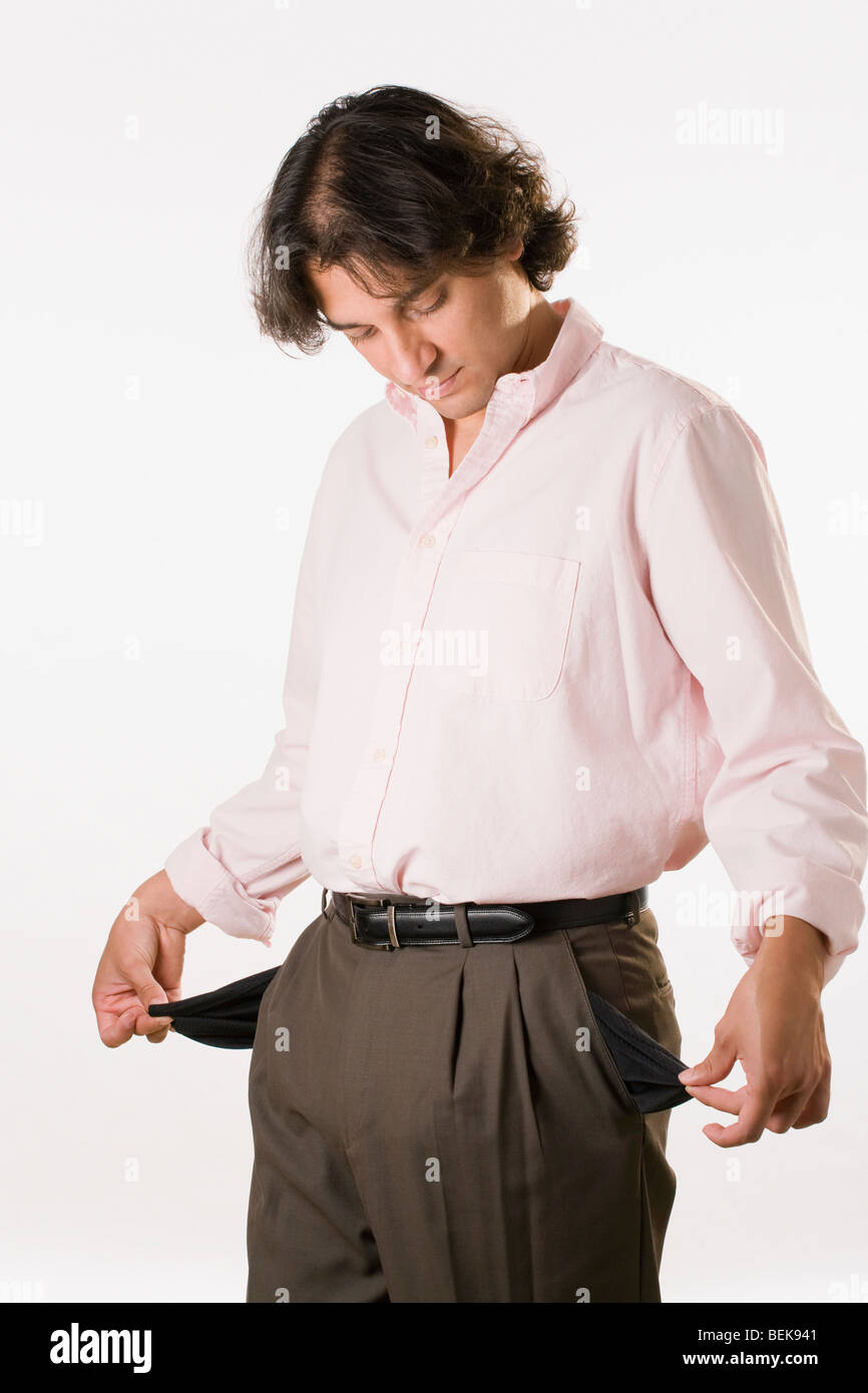 Man turning out his empty pockets Stock Photo - Alamy