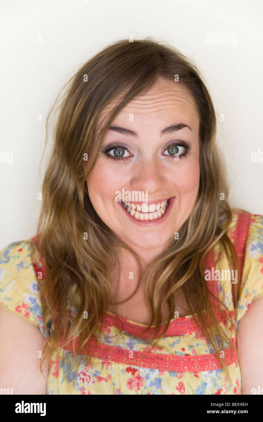 Portrait of a woman looking excited Stock Photo - Alamy