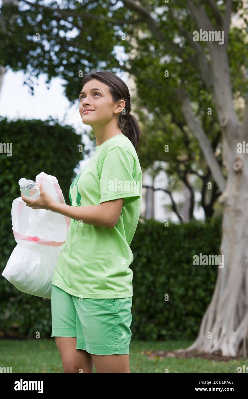 Teenage girl collecting garbage in a park Stock Photo - Alamy