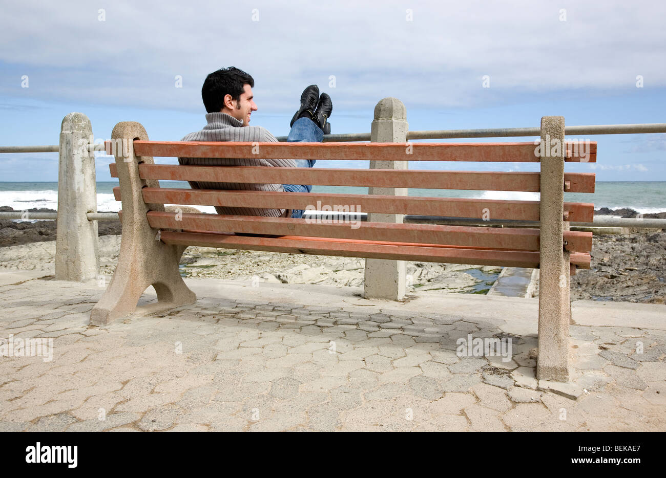 Man sitting on bench on Promenade Stock Photo - Alamy