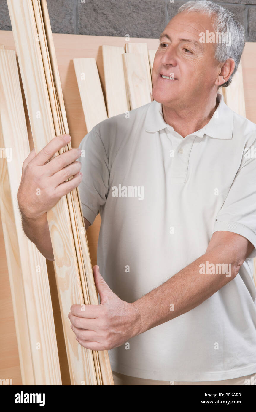 Man inspecting wooden planks Stock Photo - Alamy