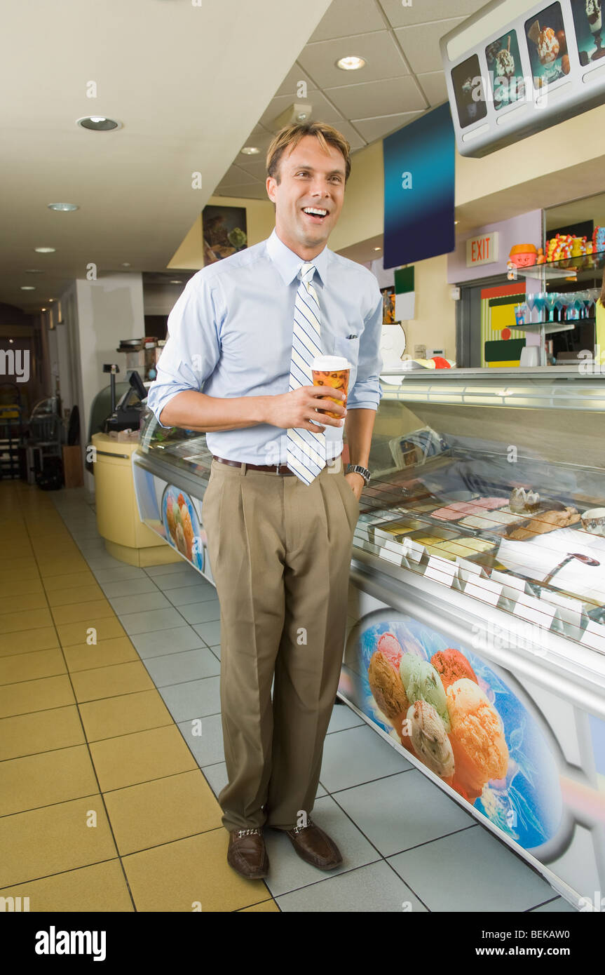 Businessman eating an ice cream in an office cafeteria Stock Photo - Alamy