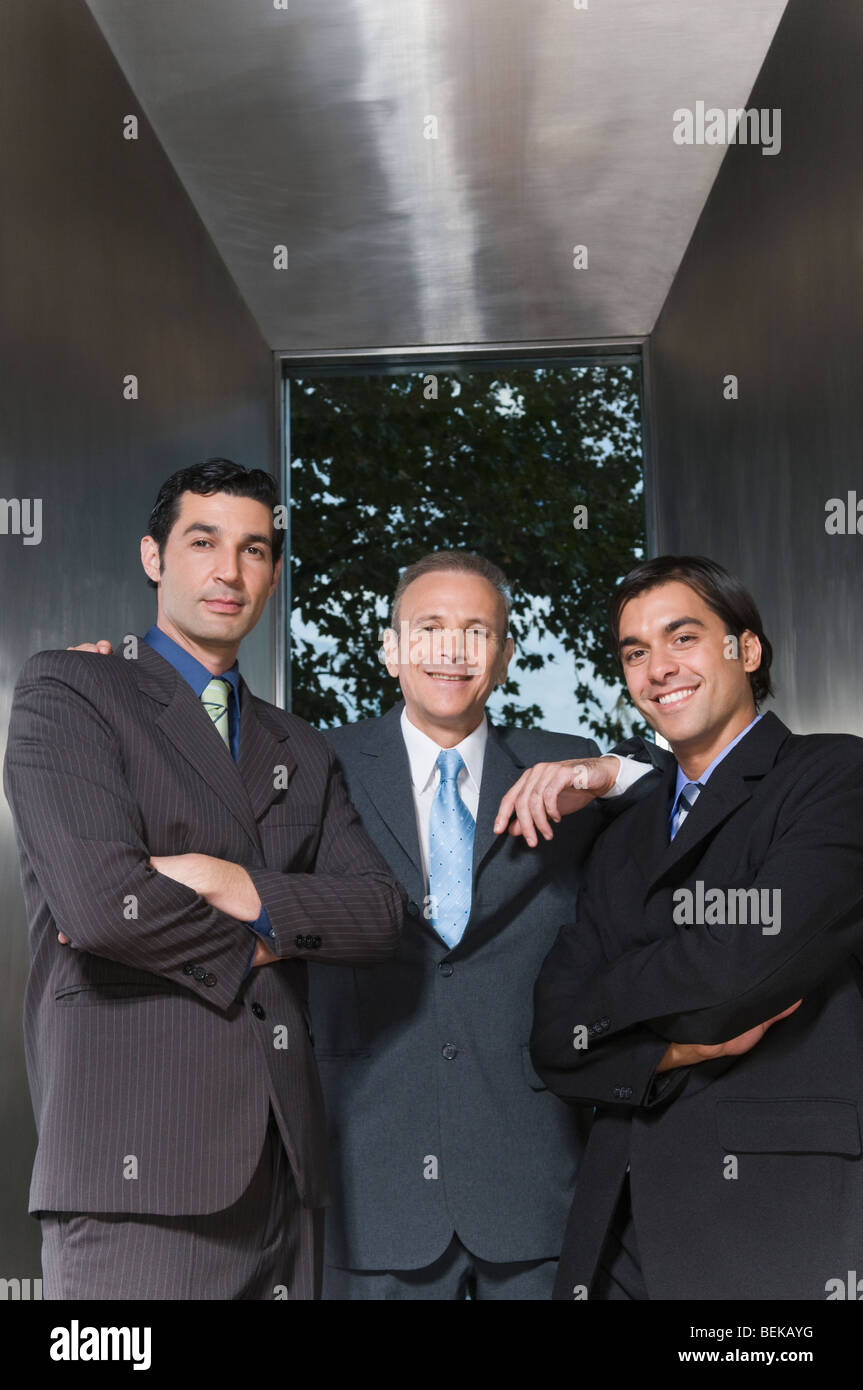 Portrait of three businessmen smiling Stock Photo - Alamy