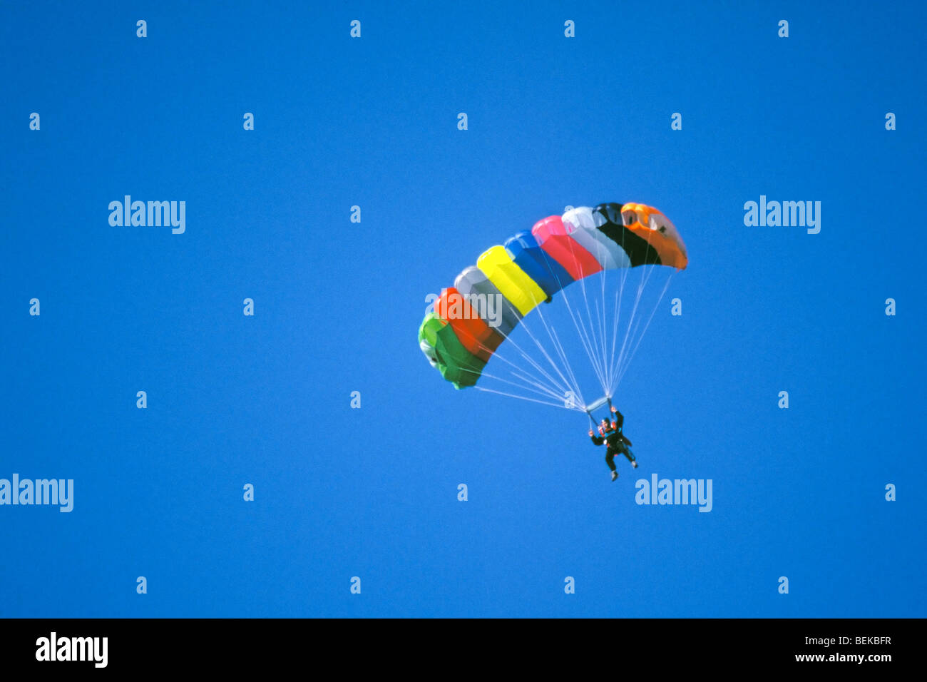 Parachutist in the sky with colourful parachute Stock Photo - Alamy