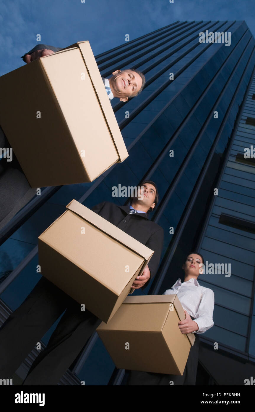 Low angle view of business executives carrying boxes Stock Photo - Alamy