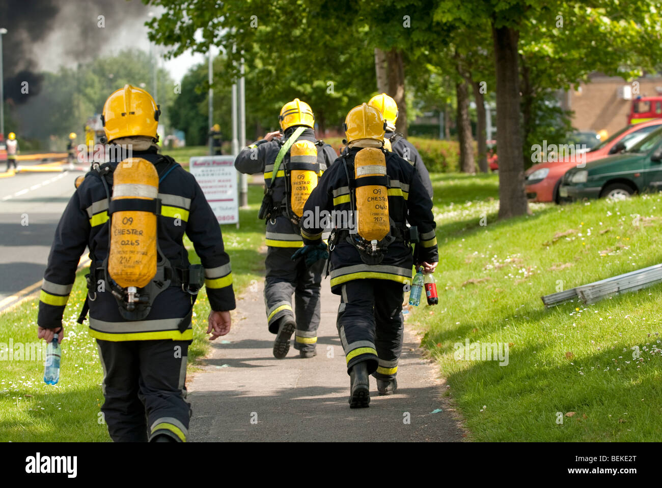Firefighers and appliance at scene of large fire with Black smoke Stock ...