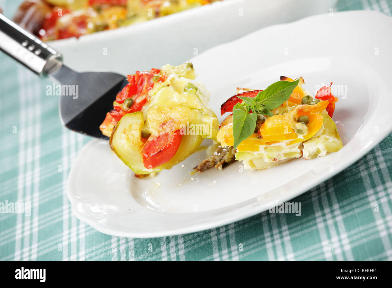 Vegetable baked pudding on white plate Stock Photo - Alamy