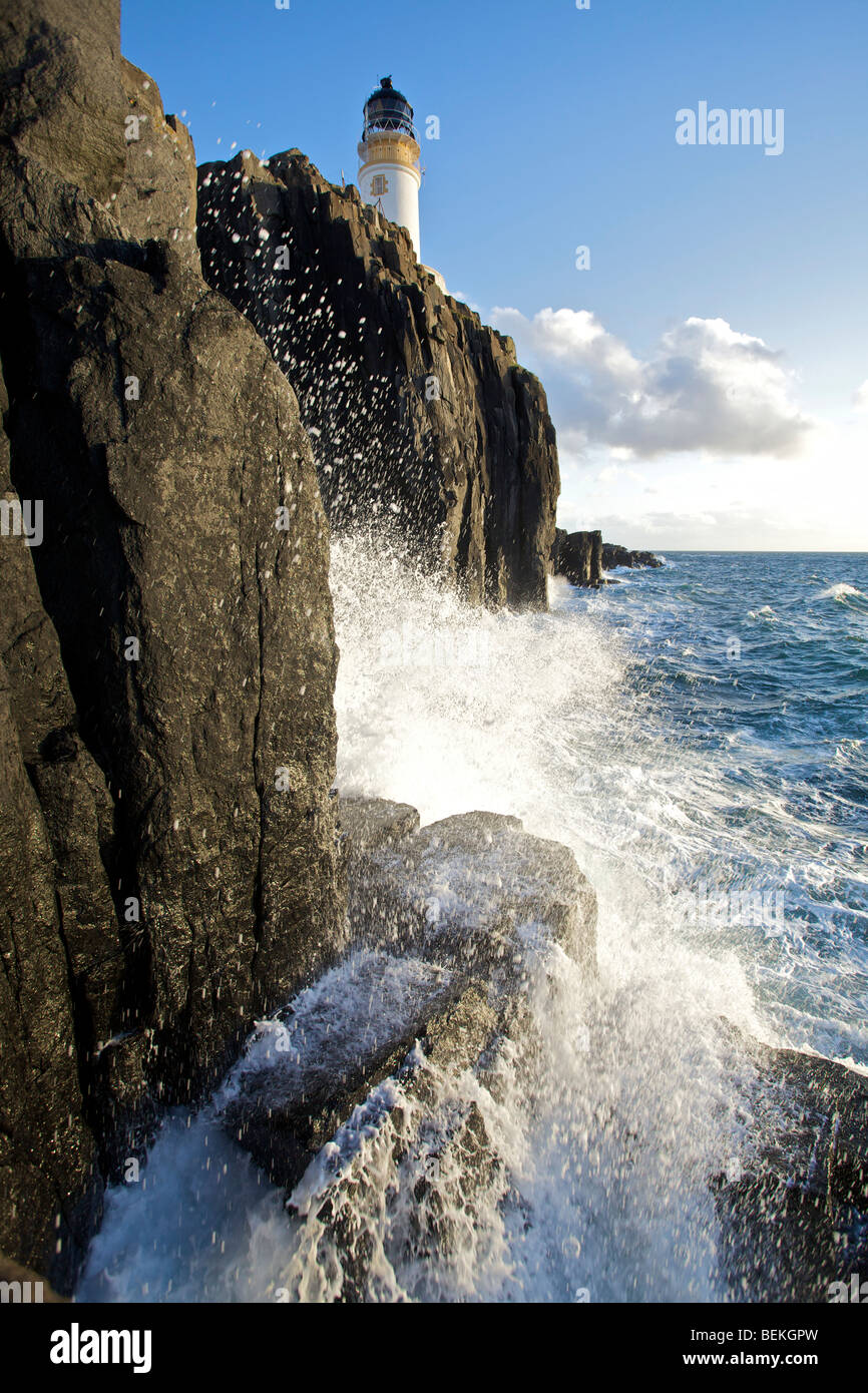 Neist Point lighthouse with rough seas pounding against the rocks in ...