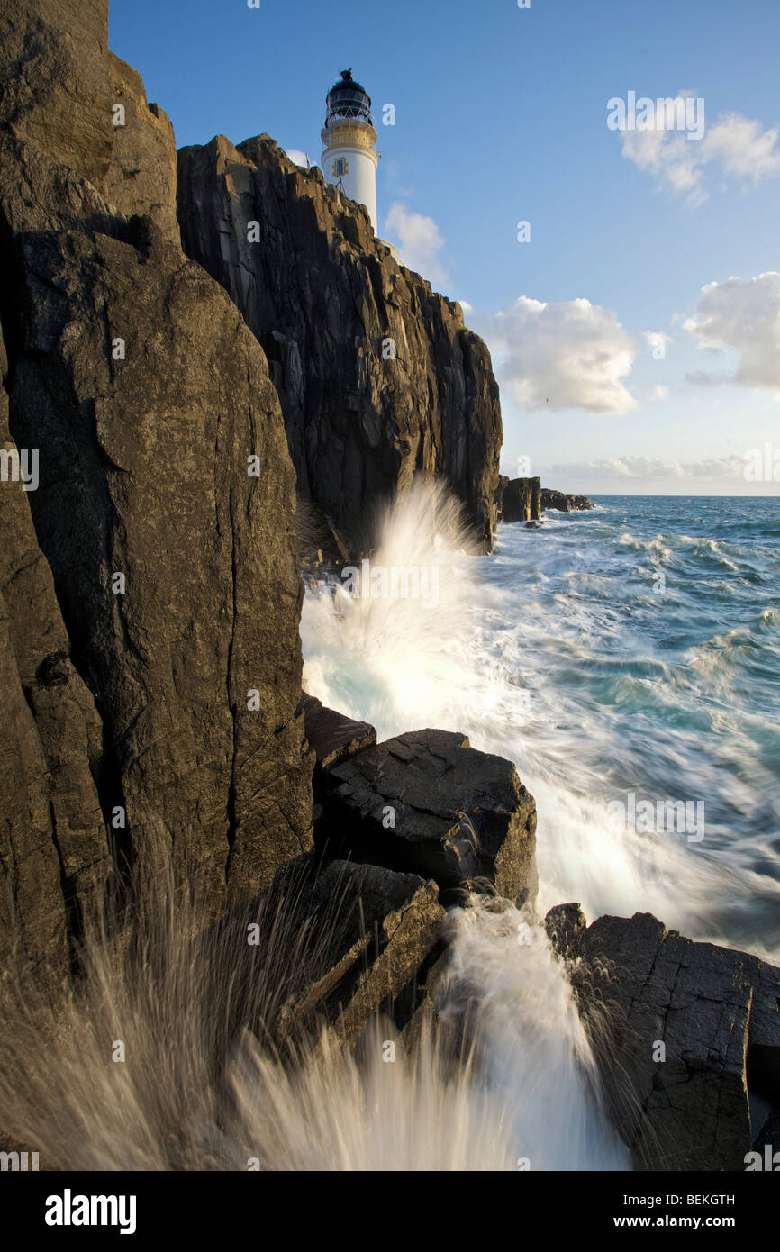 Neist Point lighthouse with rough seas pounding against the rocks in ...