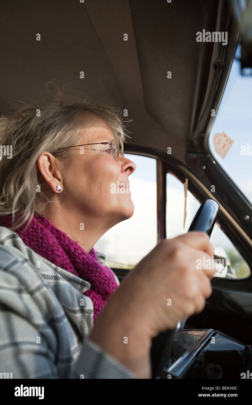 Happy senior woman driving an oldtimer car Stock Photo - Alamy