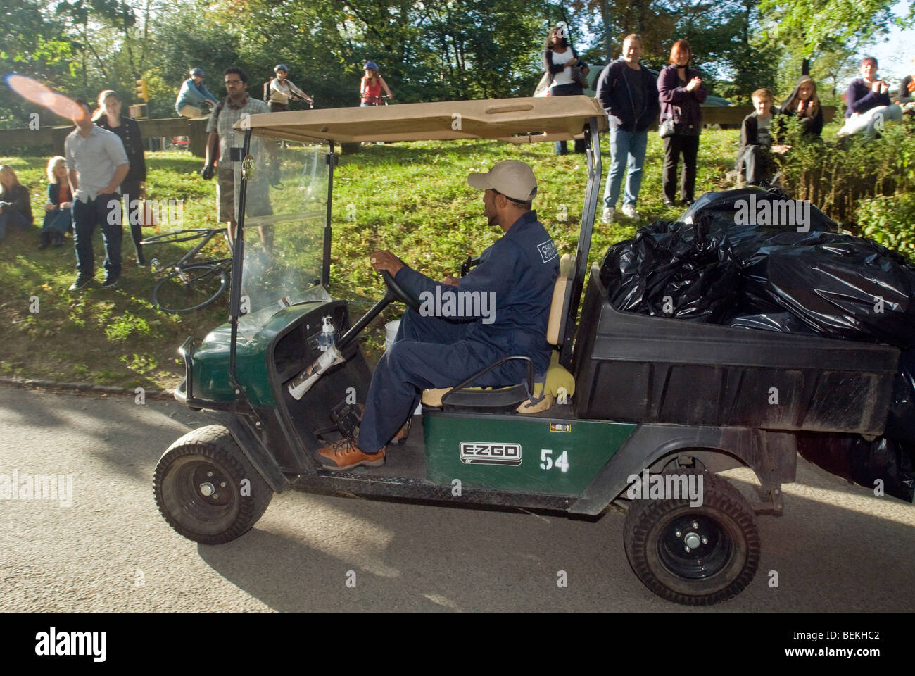 An employee of the Central Park Conservancy drives a trash collection ...