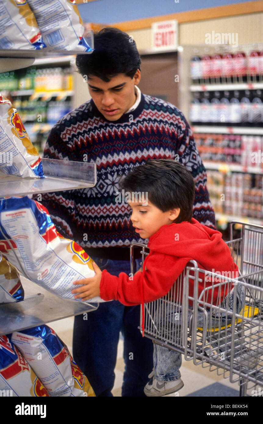 Hispanic father and son shop in grocery store market Stock Photo - Alamy